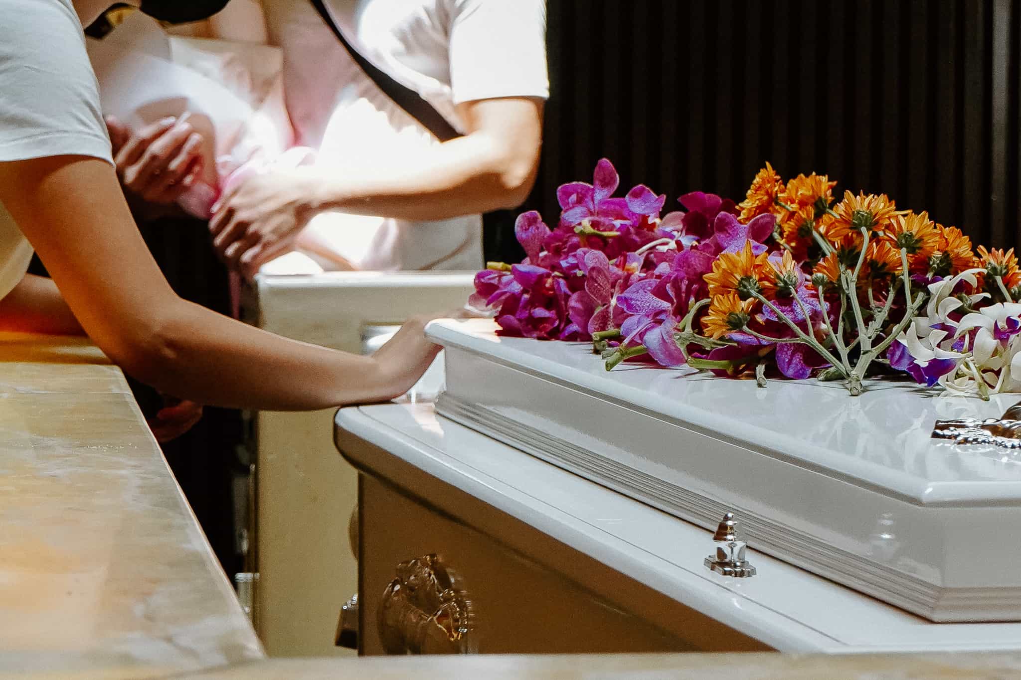 Christian – Hand on Casket – Serenity Casket